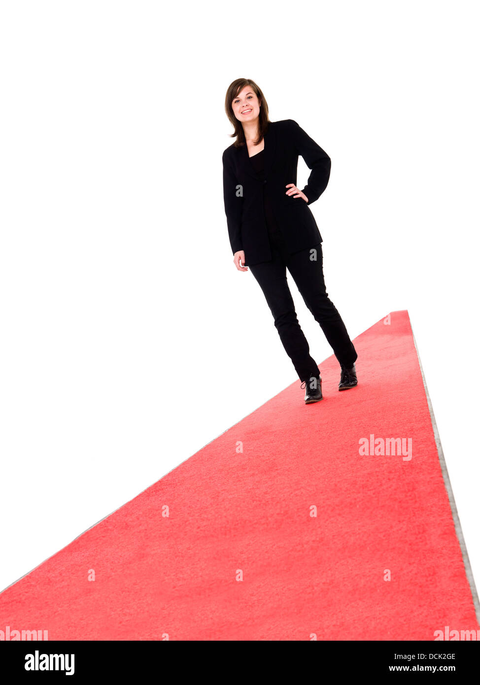 Smiling girl walking on red carpet Stock Photo - Alamy