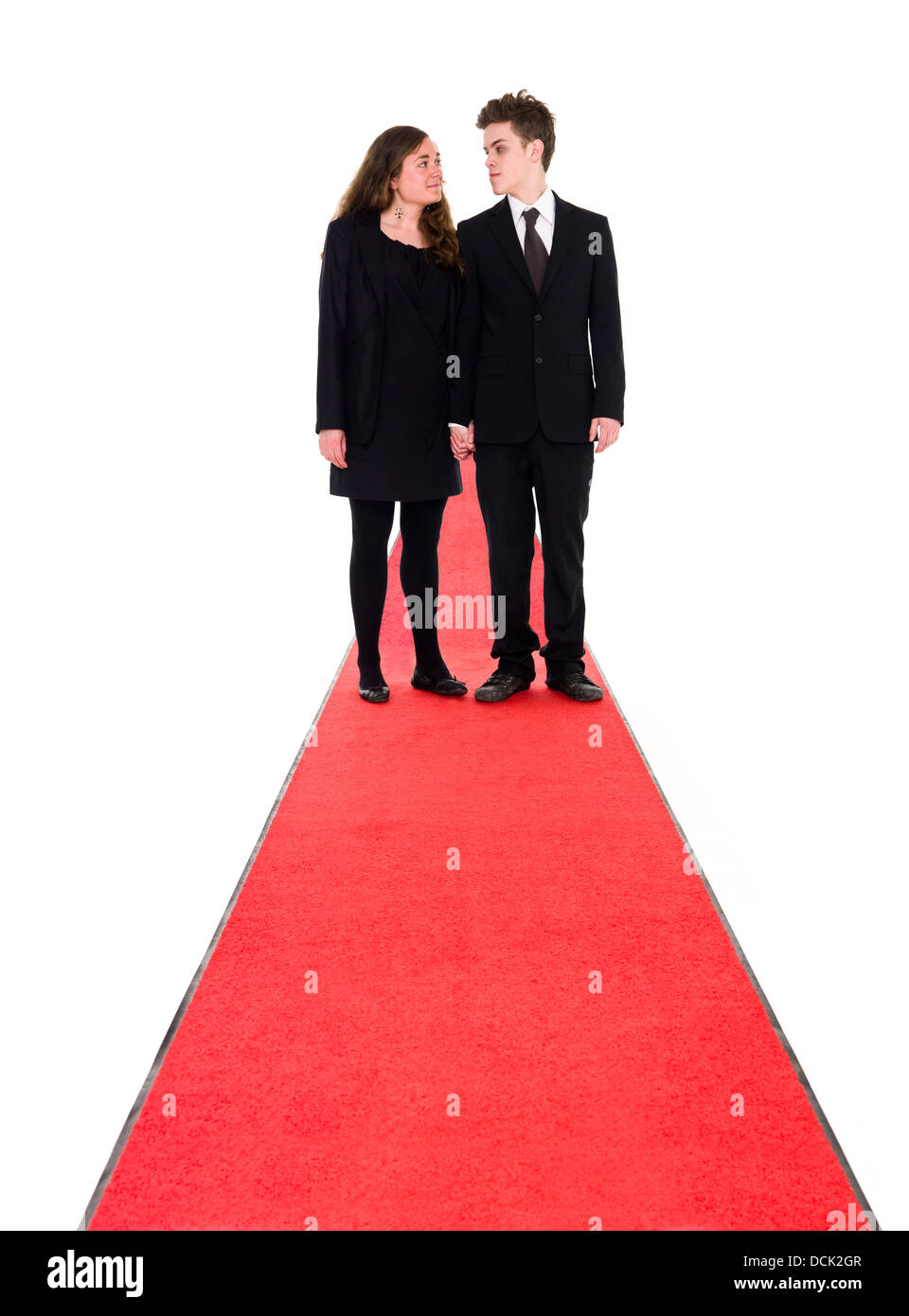 Couple standing on a red carpet Stock Photo - Alamy