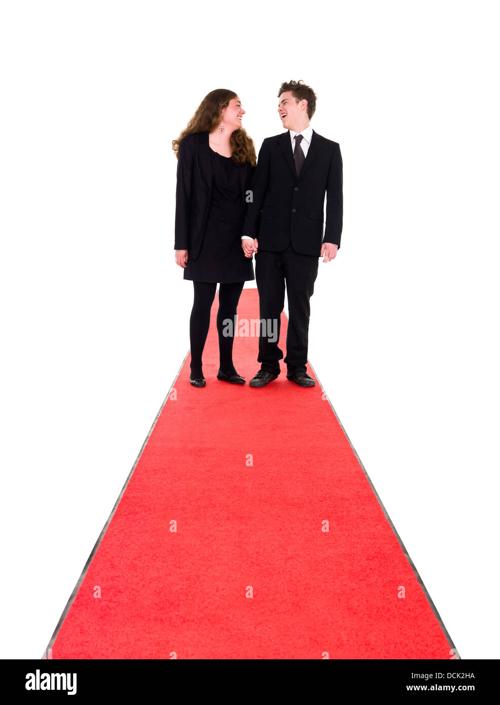 Couple standing on a red carpet Stock Photo - Alamy