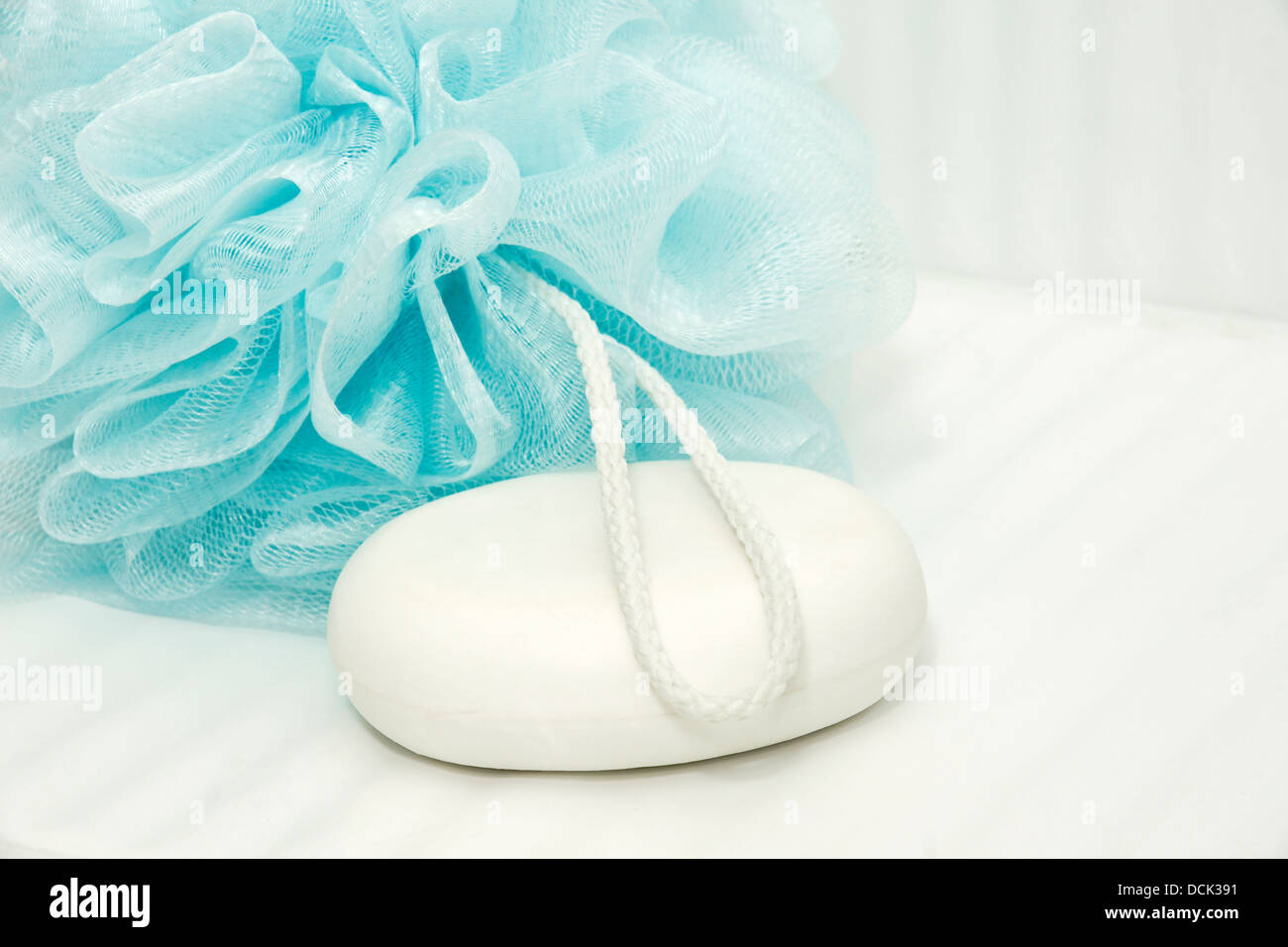 Blue shower puff and soap on tiles Stock Photo - Alamy
