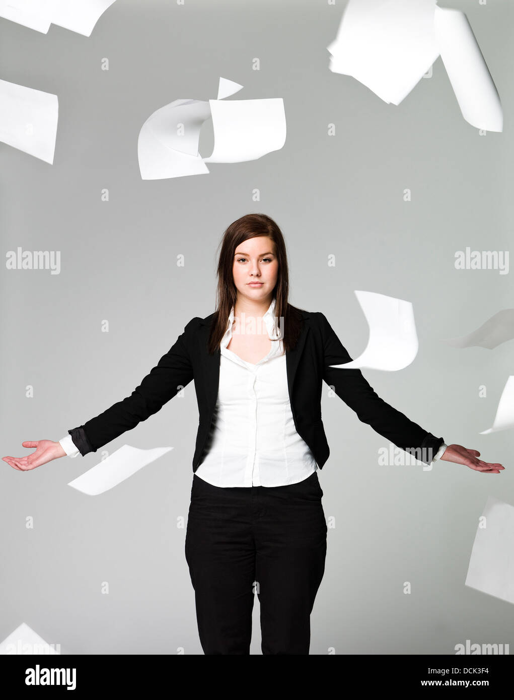 Office girl with a lots of papers flying around Stock Photo - Alamy