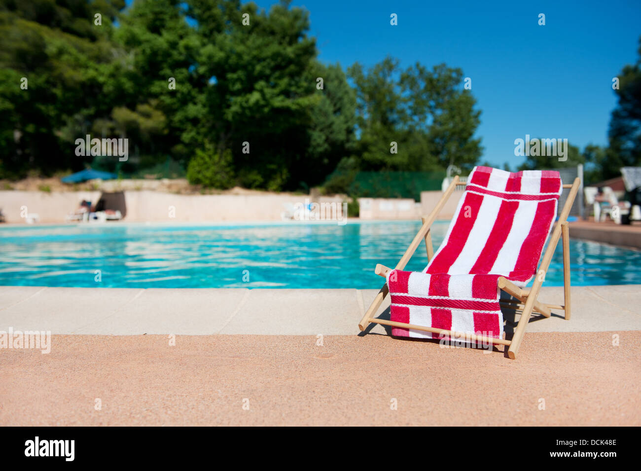 Beach chair near swimming pool Stock Photo - Alamy