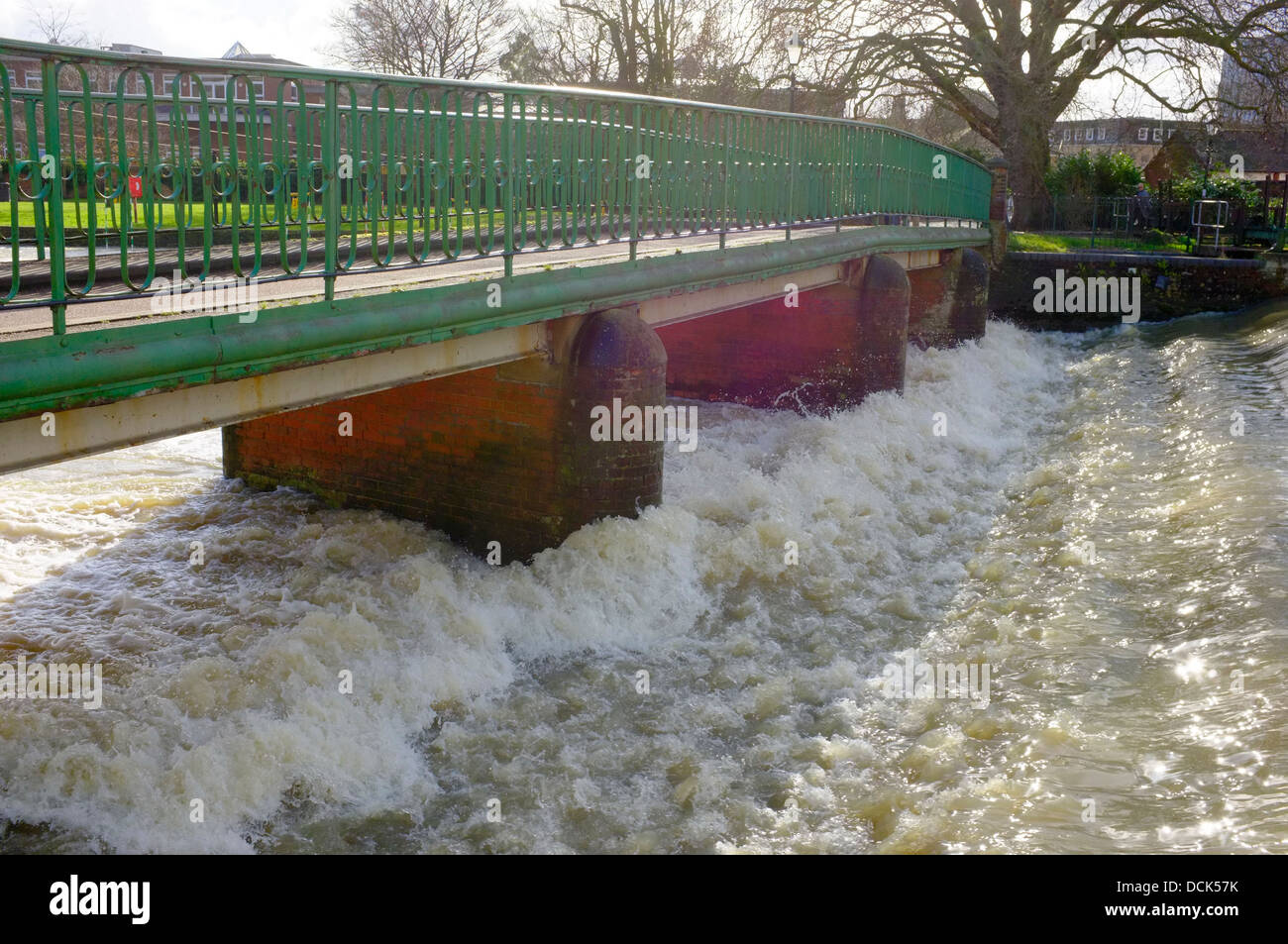 footbridge over a weir with fast flowing flood water in Bedford, UK ...