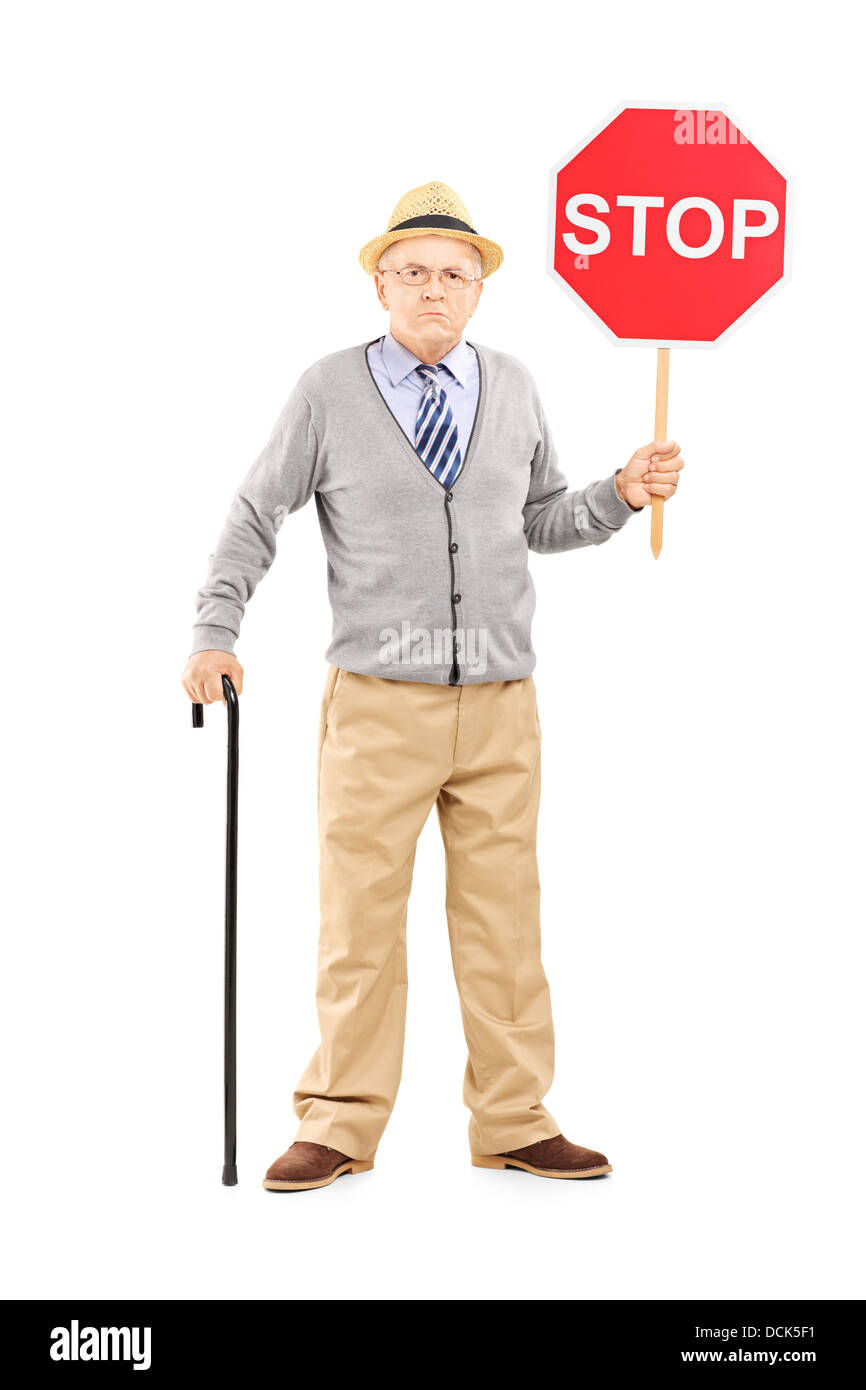 Full length portrait of an angry mature gentleman holding a stop sign ...