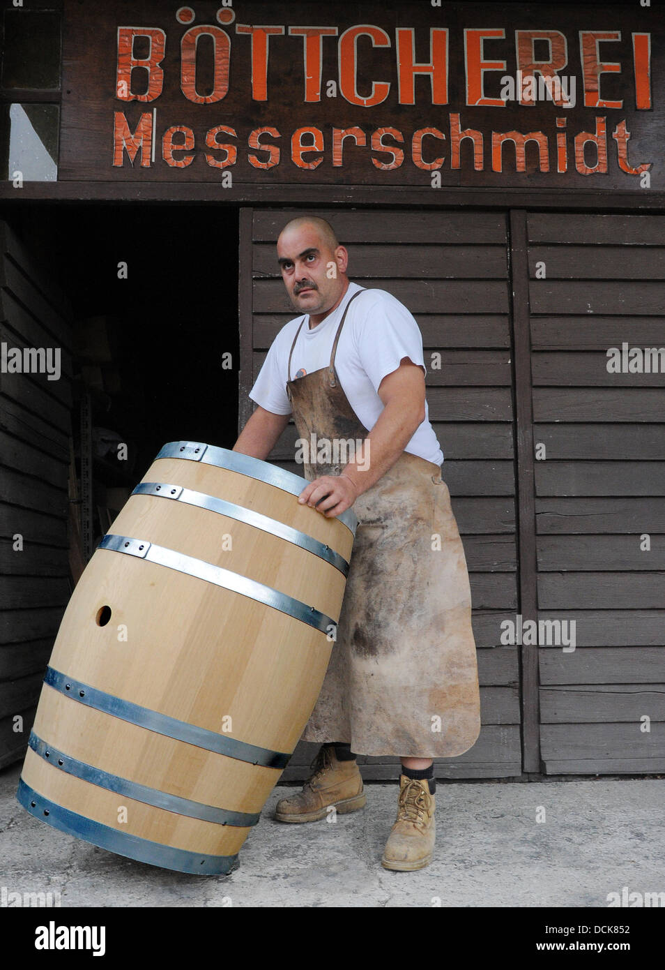 Master cooper Denis Merten rolls a barrel out of the storehouse of ...