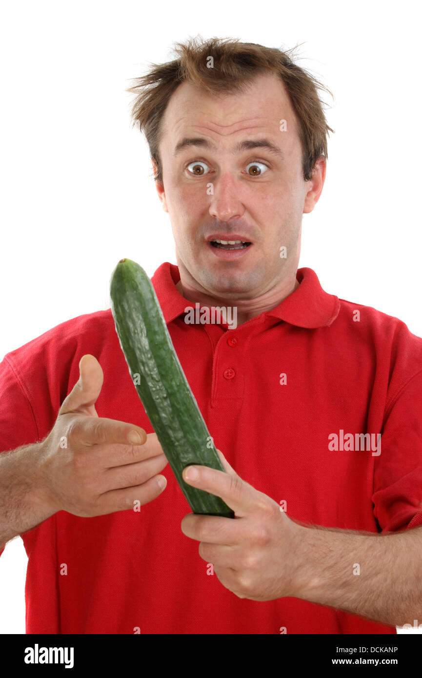 young man with a cucumber in his hand Stock Photo - Alamy
