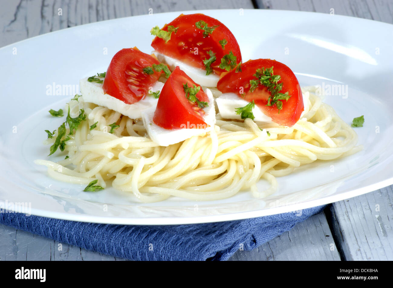 Mozzarella with tomatoes on home made spaghetti Stock Photo - Alamy