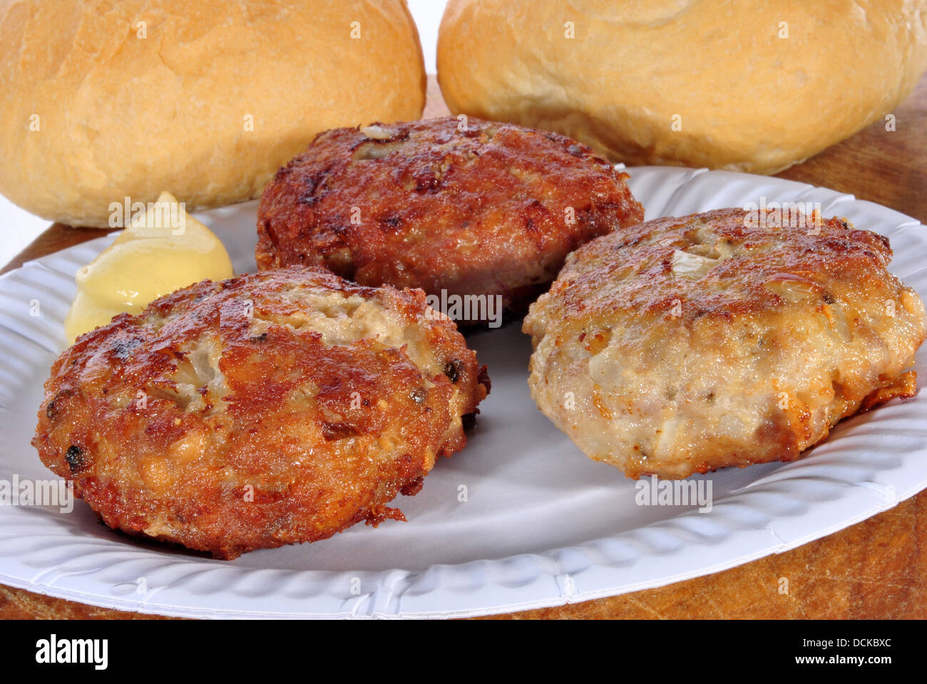 Burgers with mustard on a white paper plate Stock Photo - Alamy