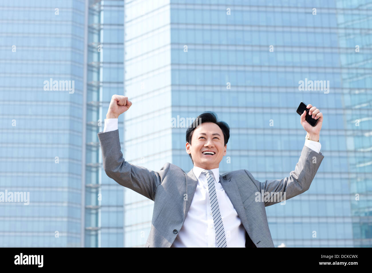 Excited businessman celebrating Stock Photo - Alamy