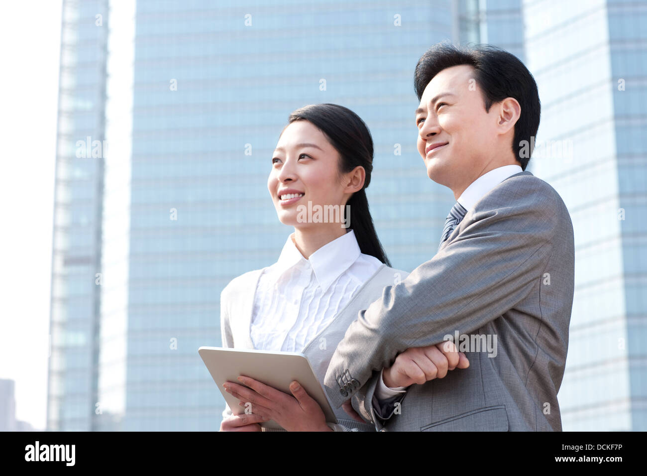 Professional business partners looking at view Stock Photo - Alamy