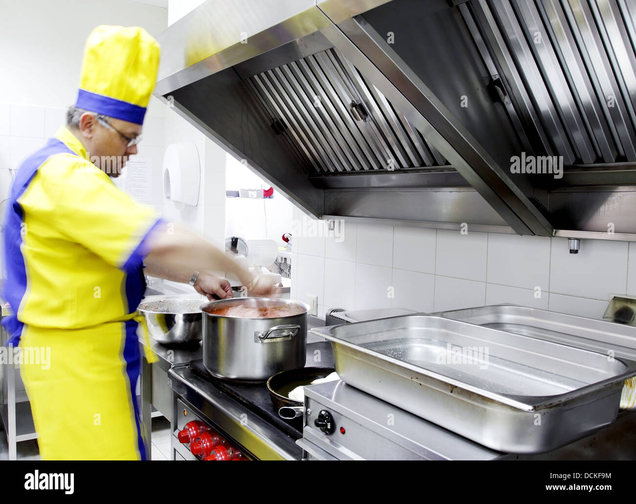 cook over stove Stock Photo - Alamy