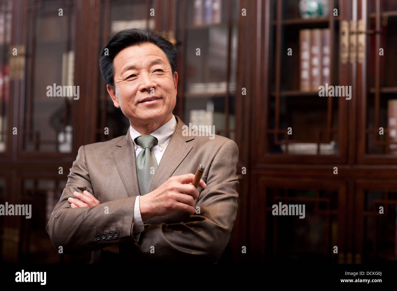 Successful businessman enjoying cigar Stock Photo - Alamy
