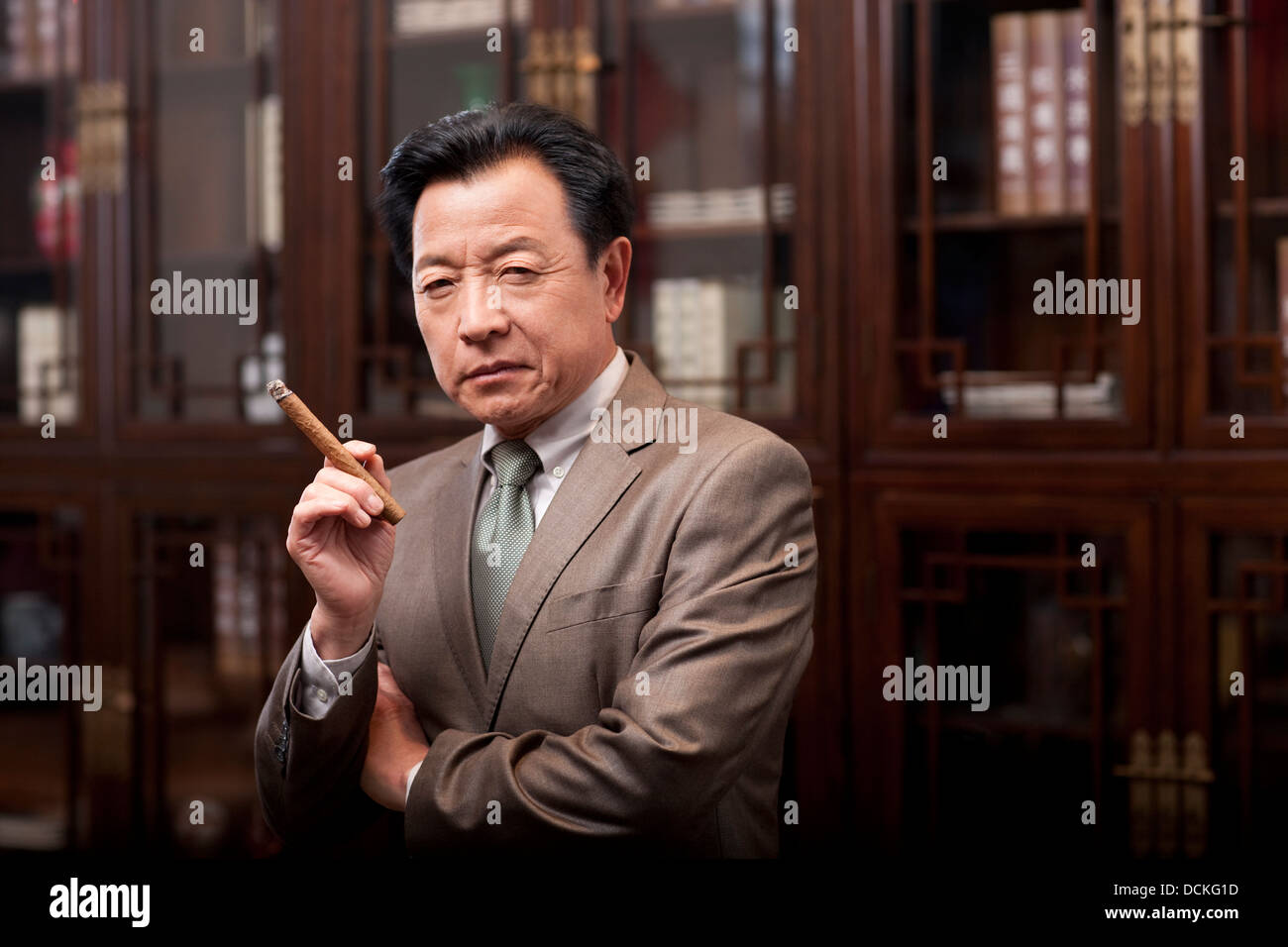 Successful businessman enjoying cigar Stock Photo - Alamy