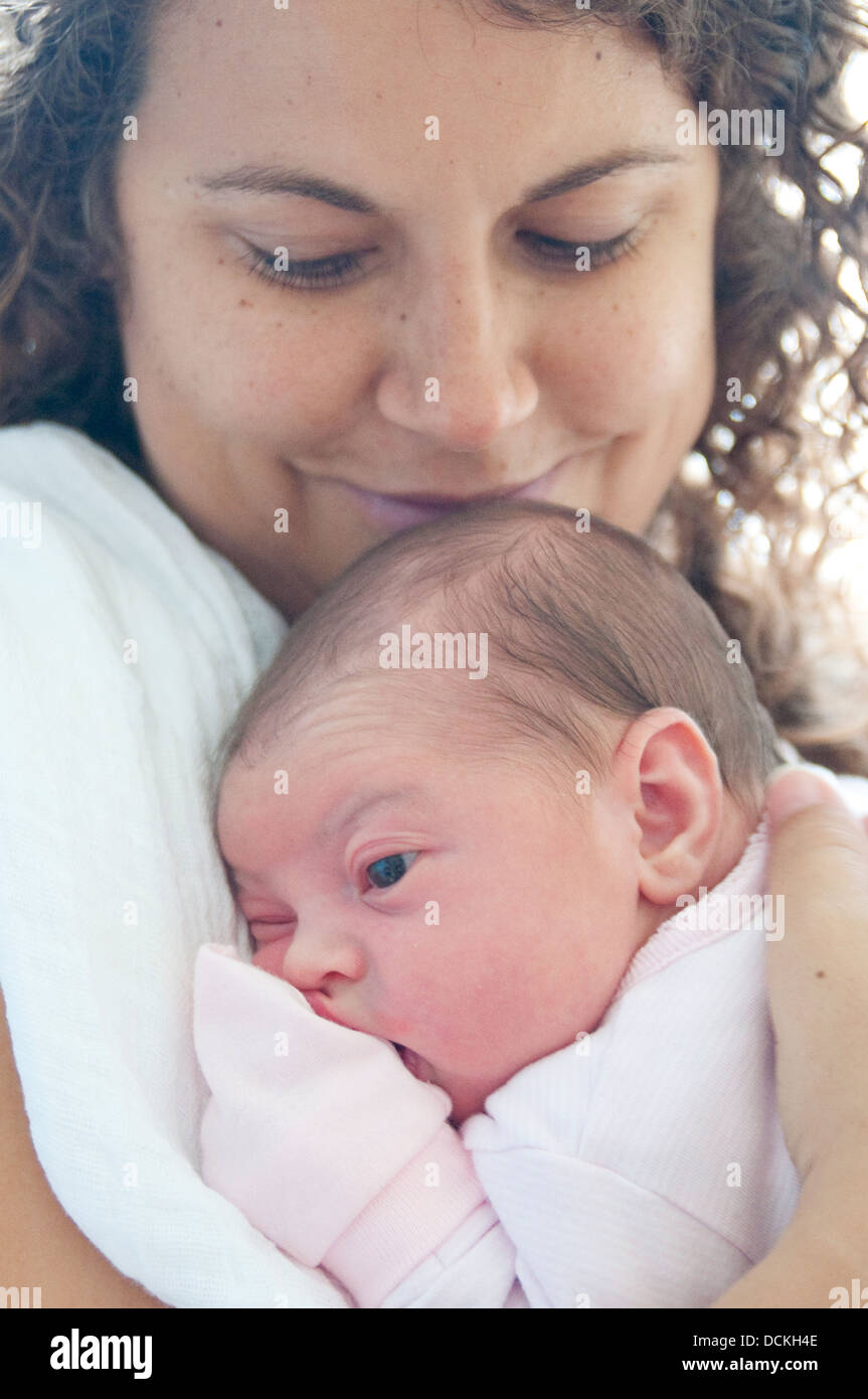 young mother holding new born baby Stock Photo - Alamy