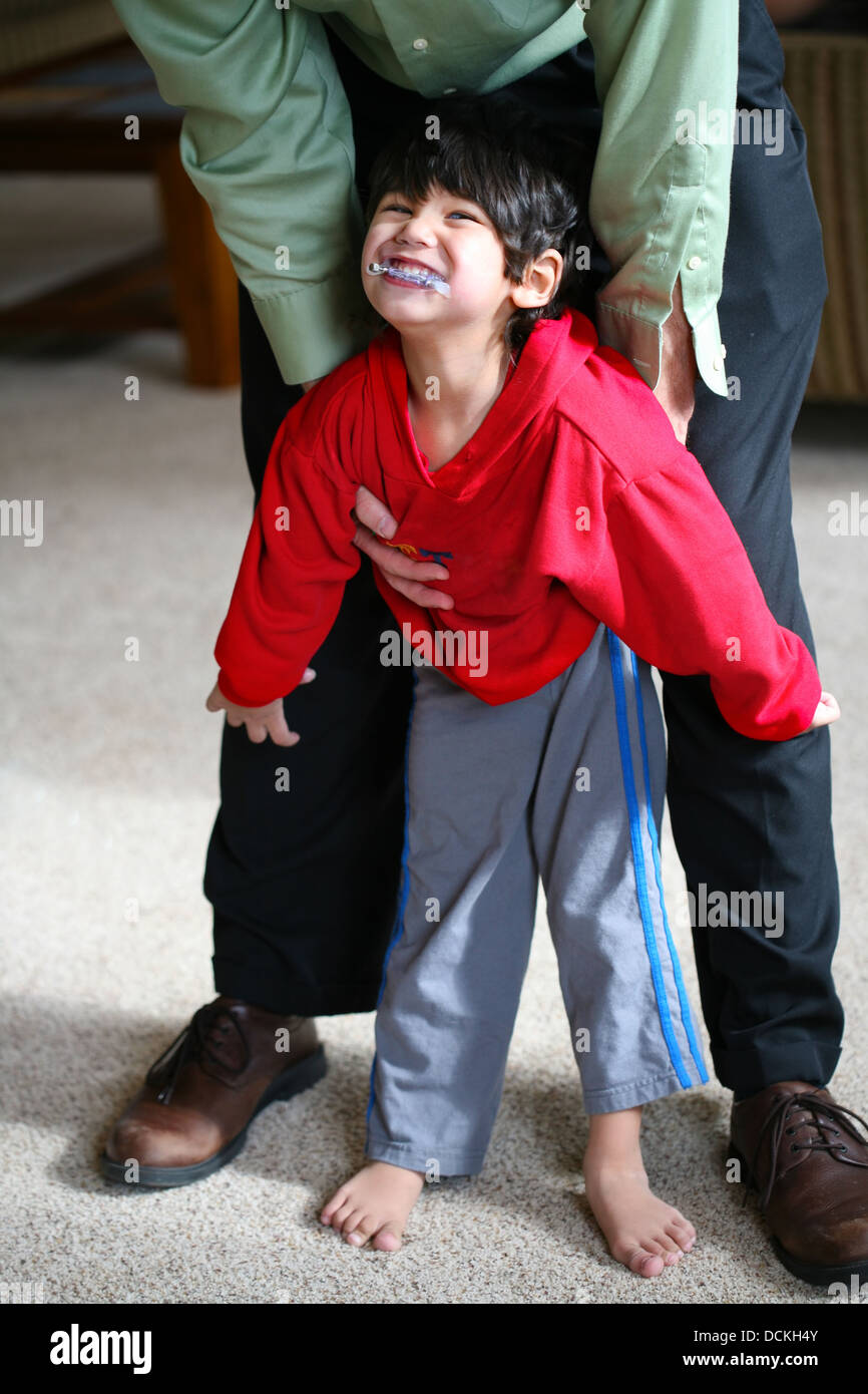 Father helping his disabled son to walk Stock Photo - Alamy