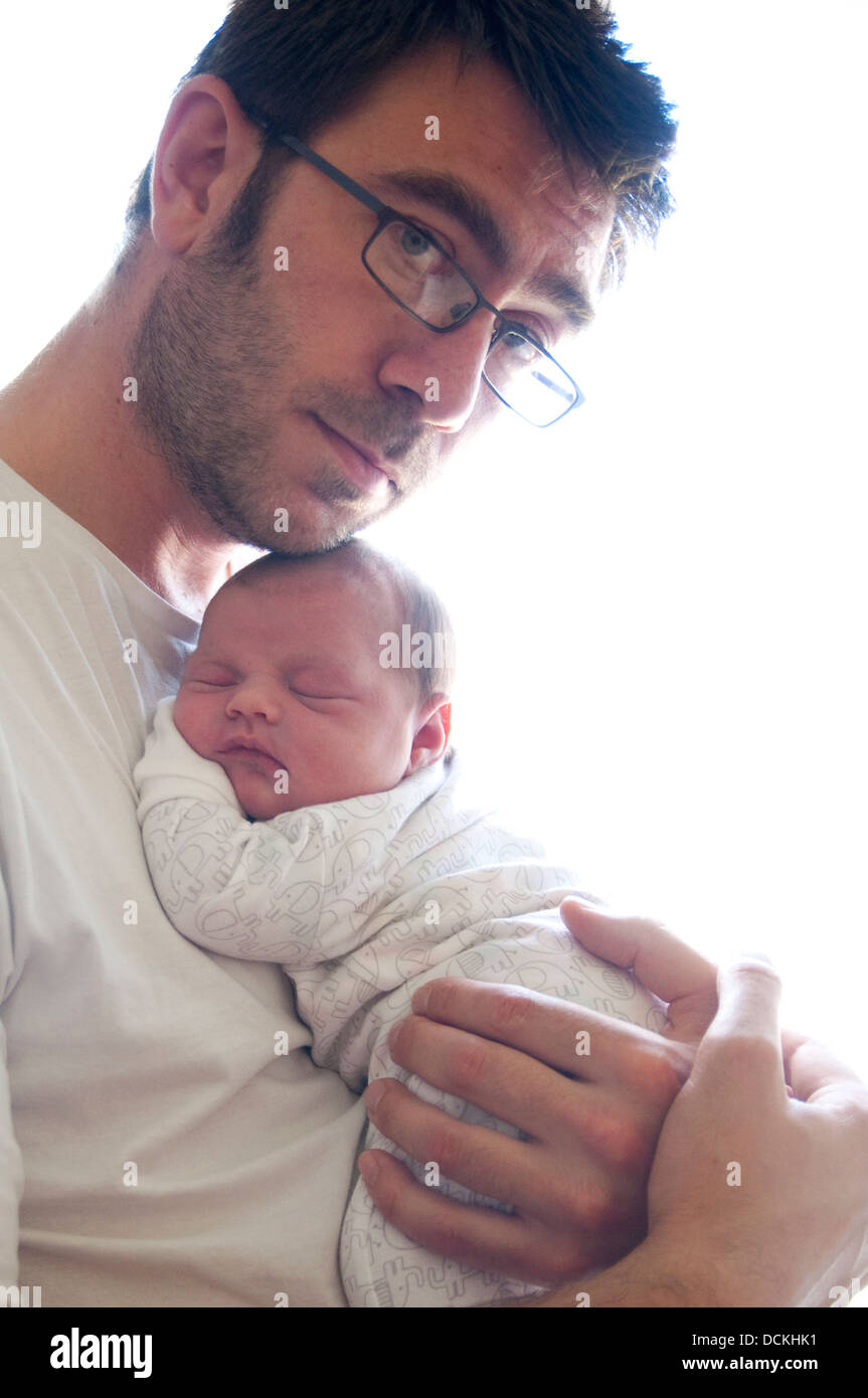 Father protectively holding his new born daughter Stock Photo - Alamy