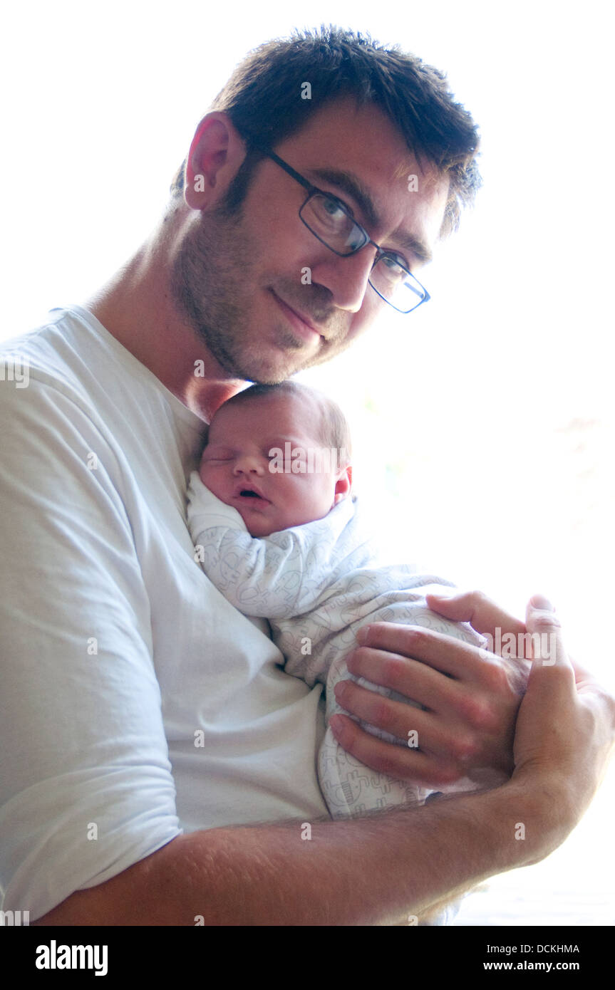 Father protectively holding his new born daughter Stock Photo - Alamy