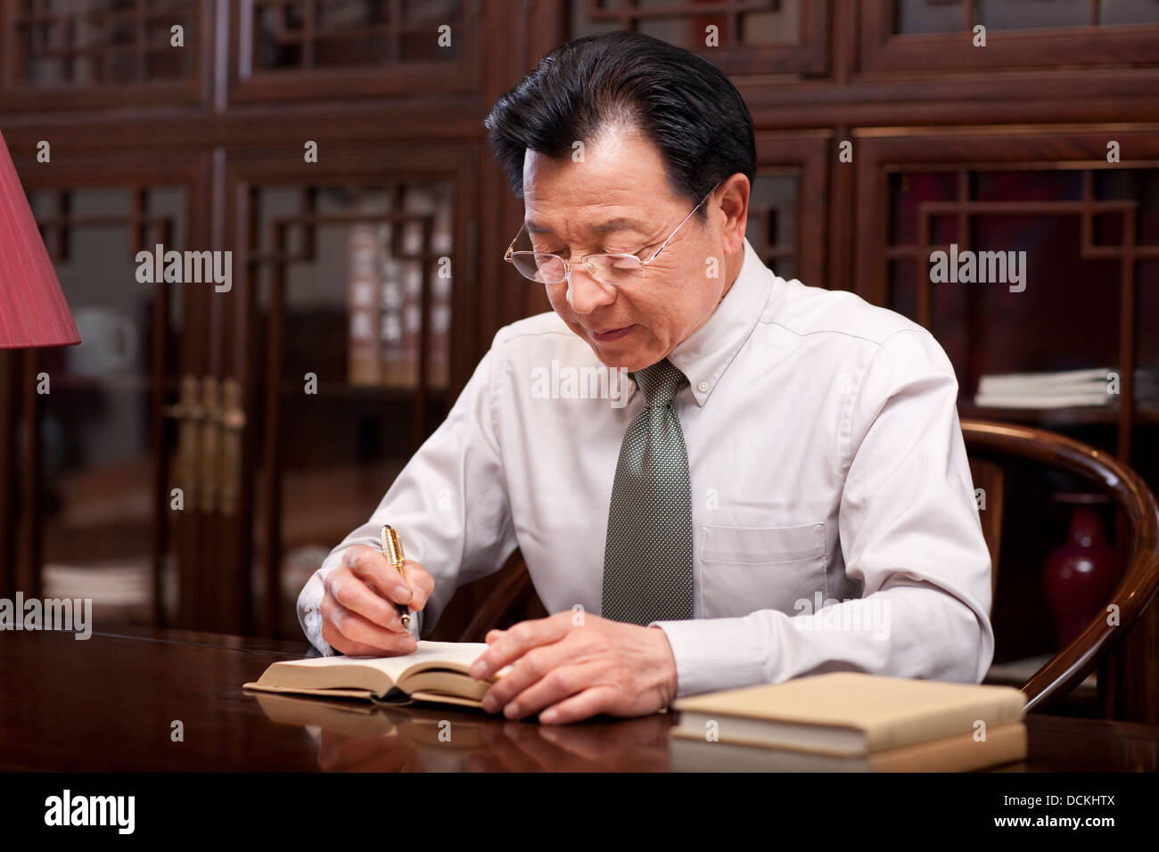 Businessman reading a book Stock Photo - Alamy