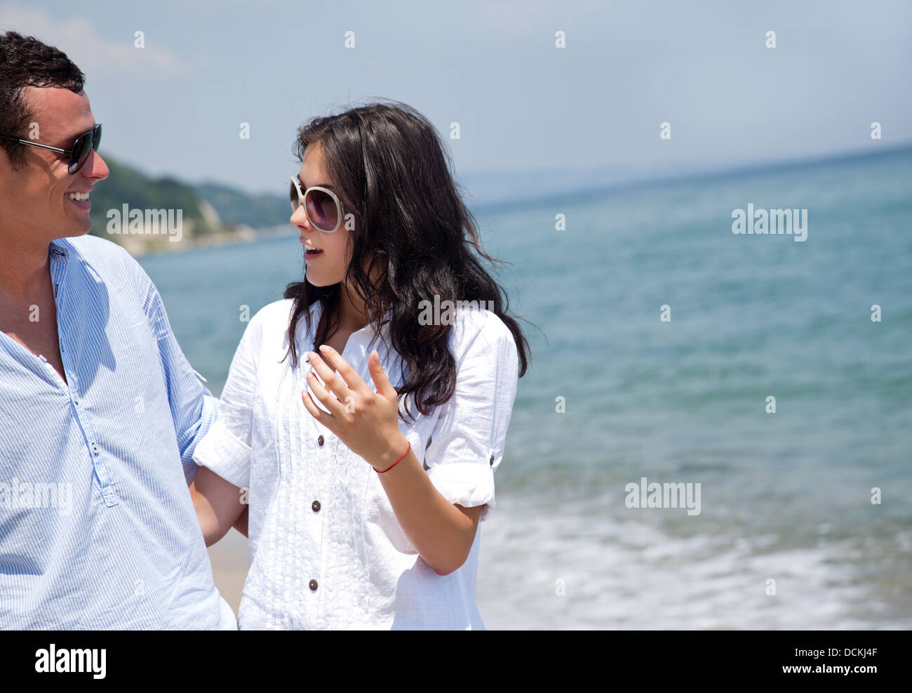 couple beach talk Stock Photo - Alamy