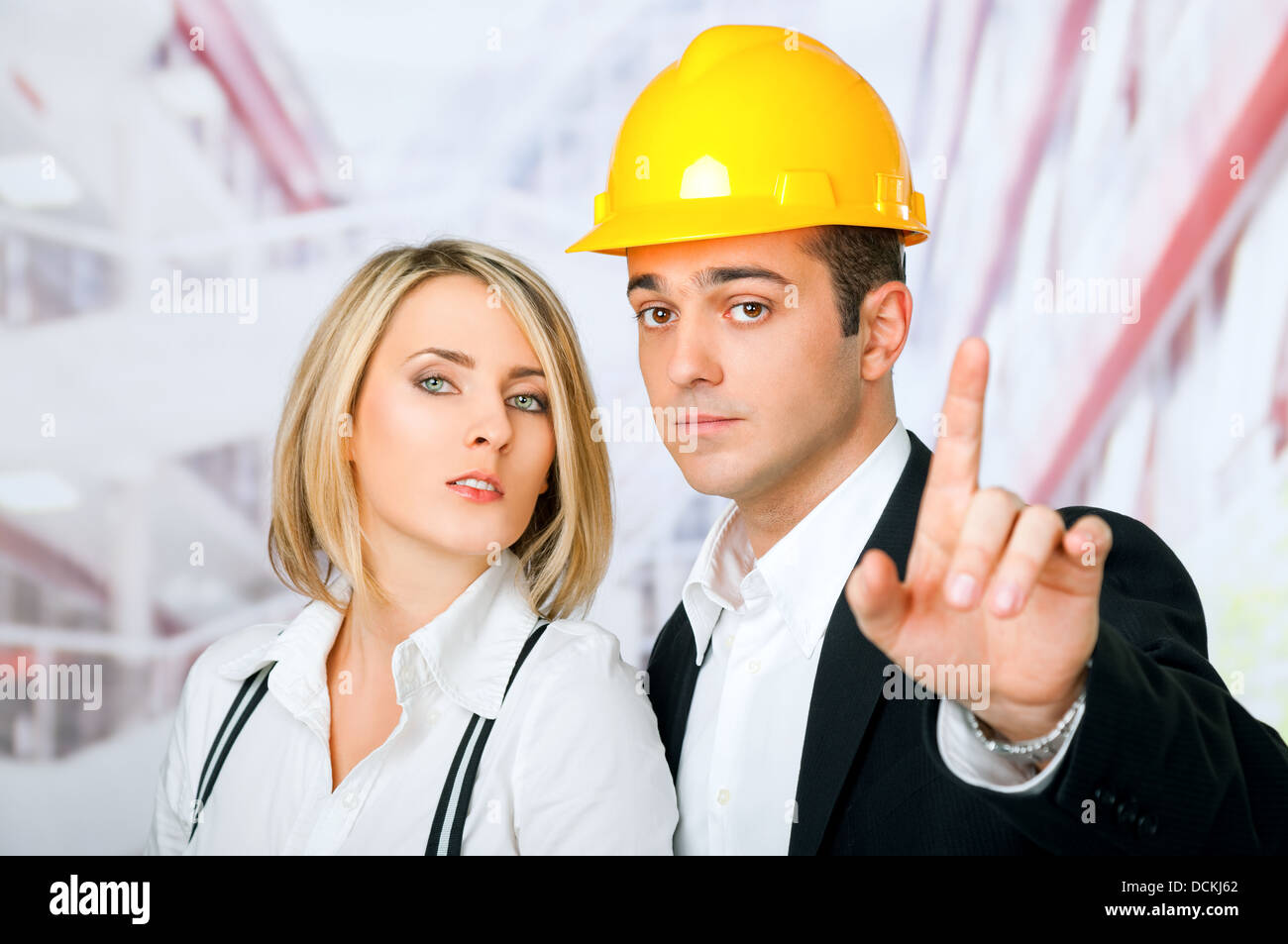 Male female architects pointing Stock Photo - Alamy