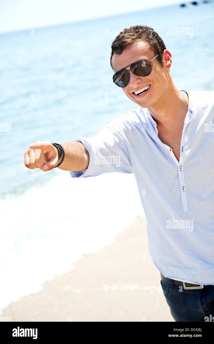 Man pointing beach Stock Photo - Alamy