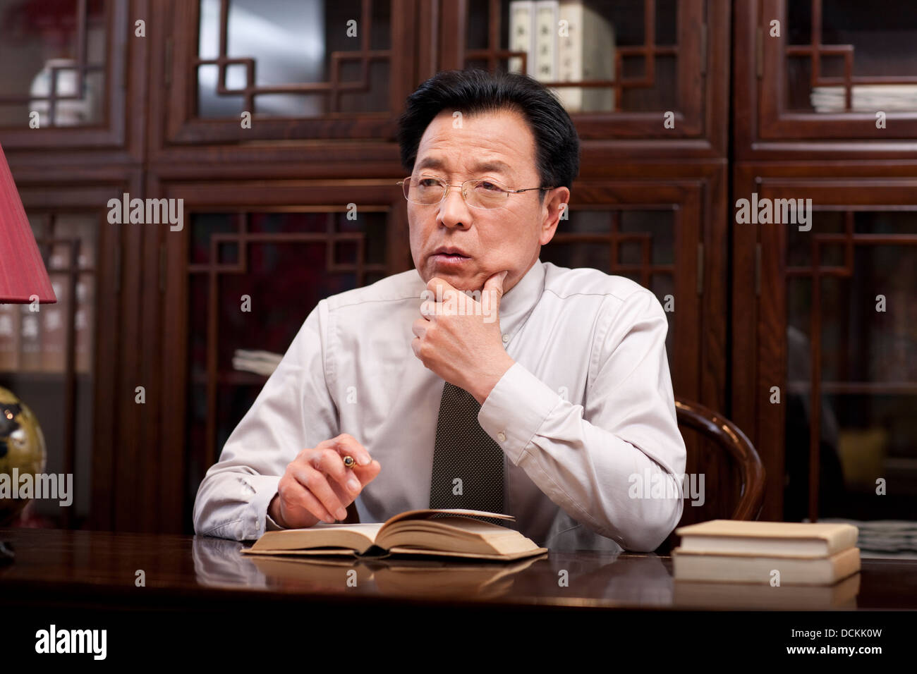 Businessman reading a book Stock Photo - Alamy
