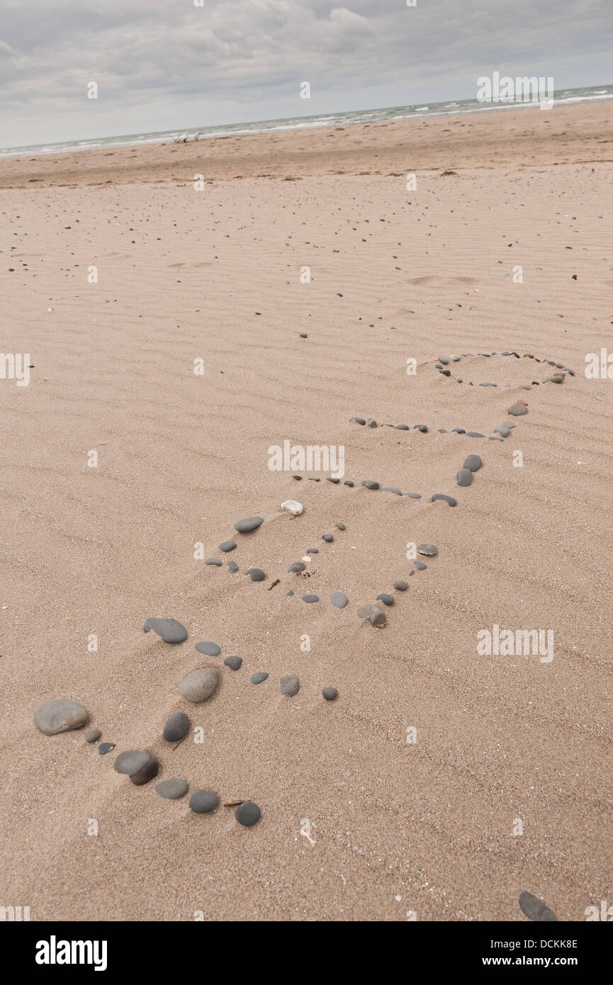 Hello word made from pebbles made at low tide as sea leaves beach ...