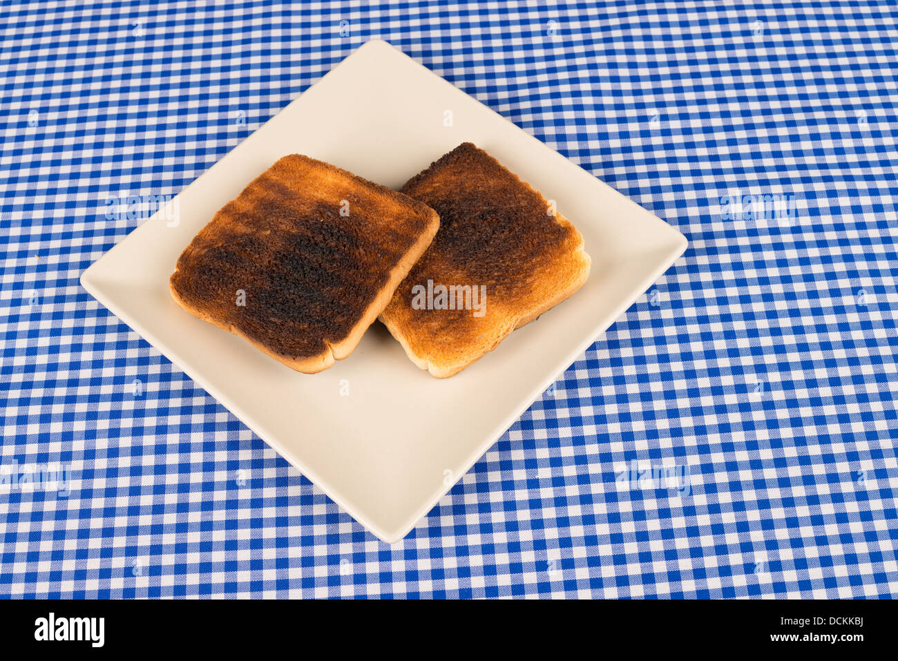 Toasting bread after having gone a bit wrong Stock Photo - Alamy