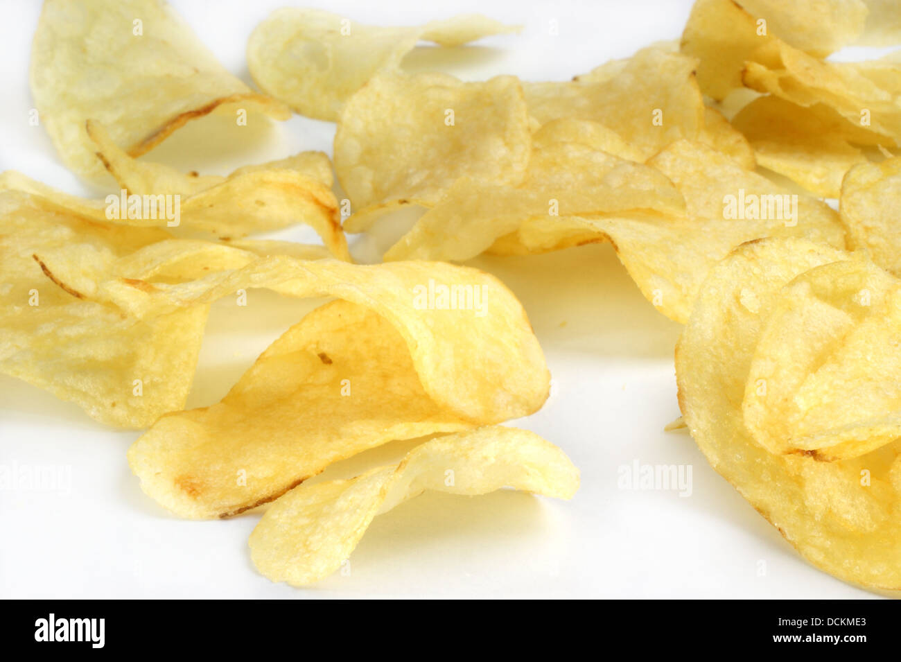 a few potato chips on a light background Stock Photo - Alamy