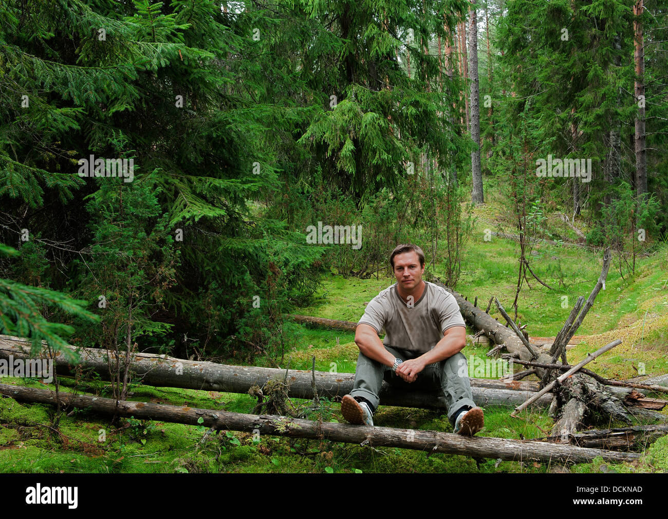 Man on log Stock Photo - Alamy
