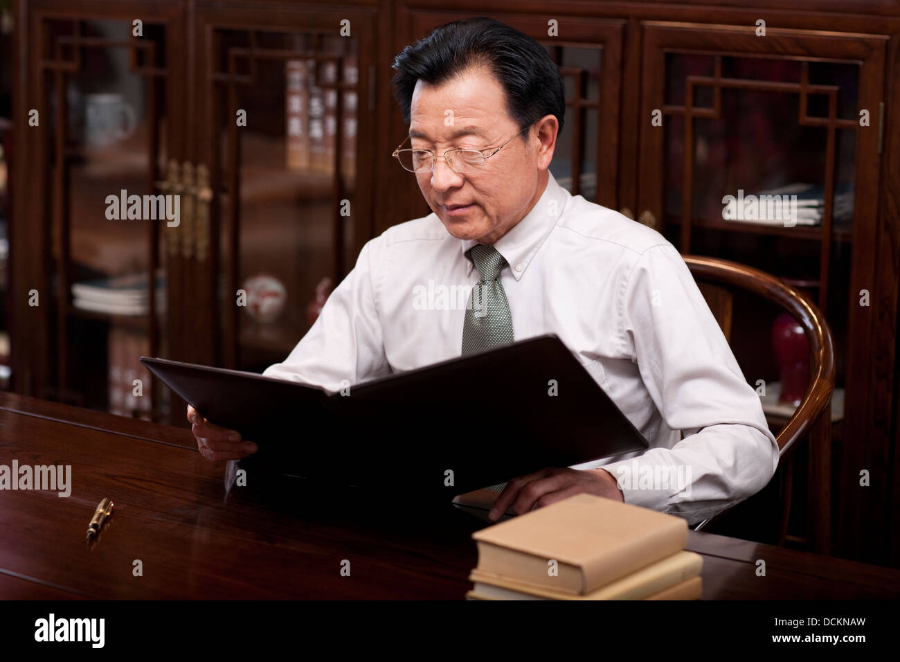 Smiling looking away authority sitting document hi-res stock ...