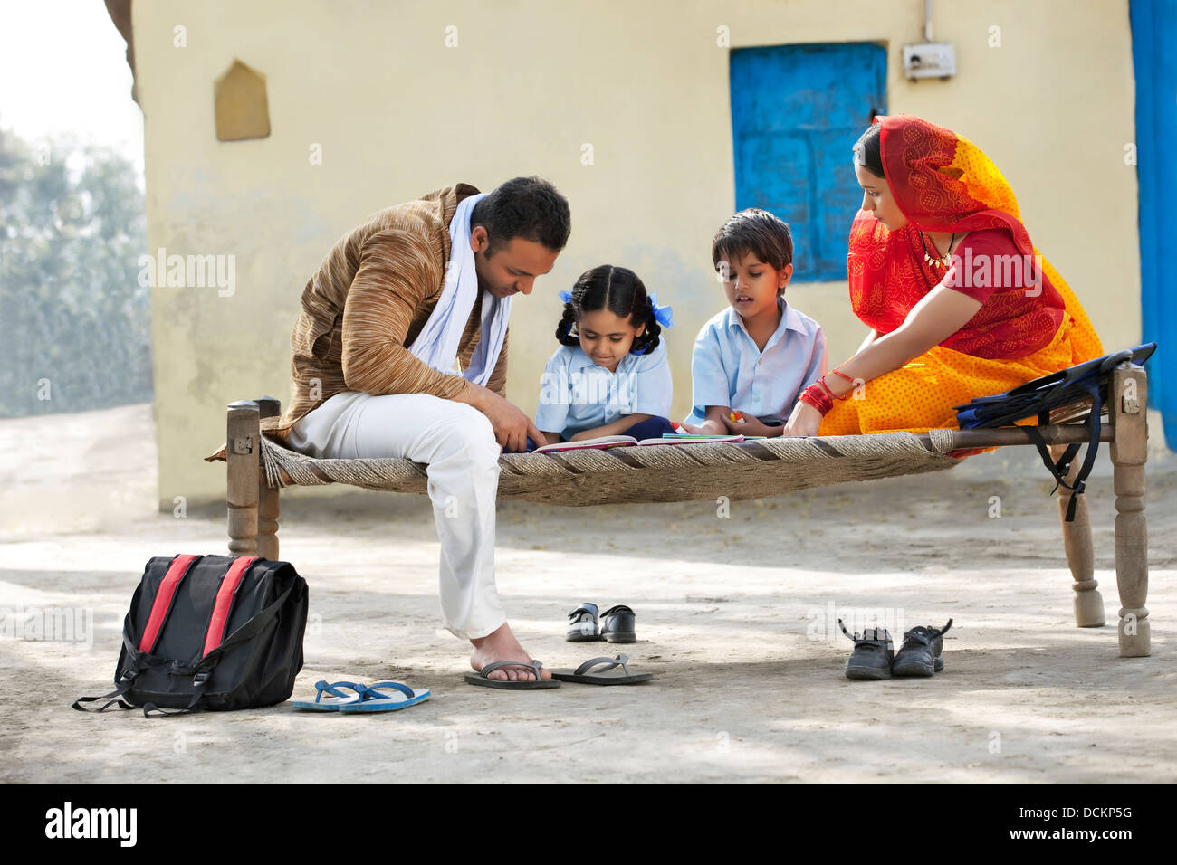 Parents helping children with their homework Stock Photo - Alamy