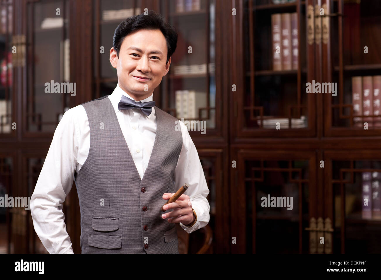 Successful businessman with cigar Stock Photo - Alamy