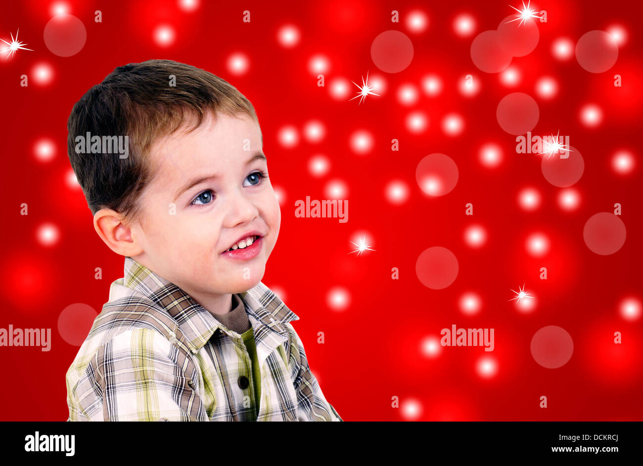 Cute little boy on red background with lights Stock Photo - Alamy