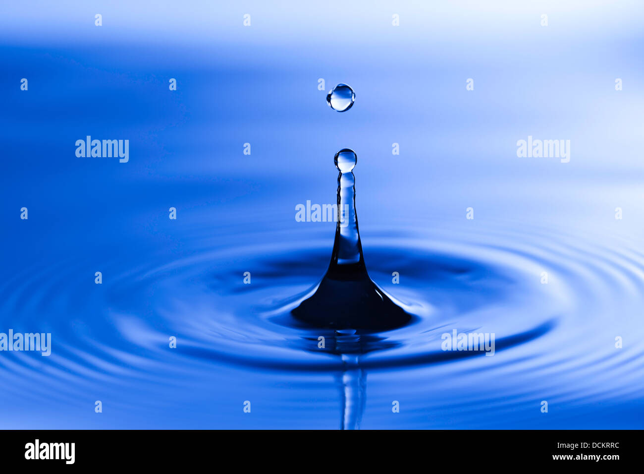 Water drop falling to a liquid surface Stock Photo - Alamy