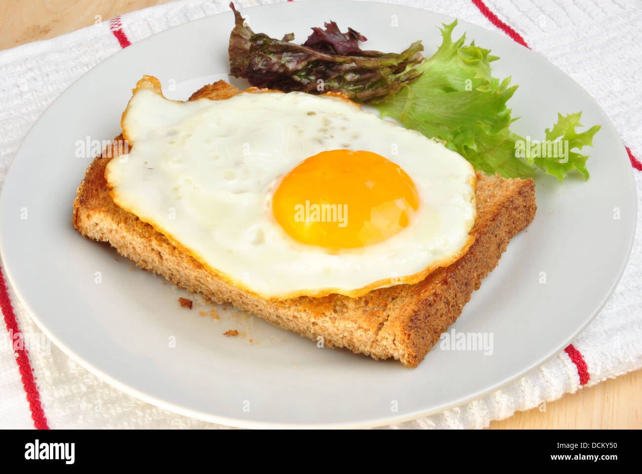 organic fried egg on toast bread with salad Stock Photo - Alamy