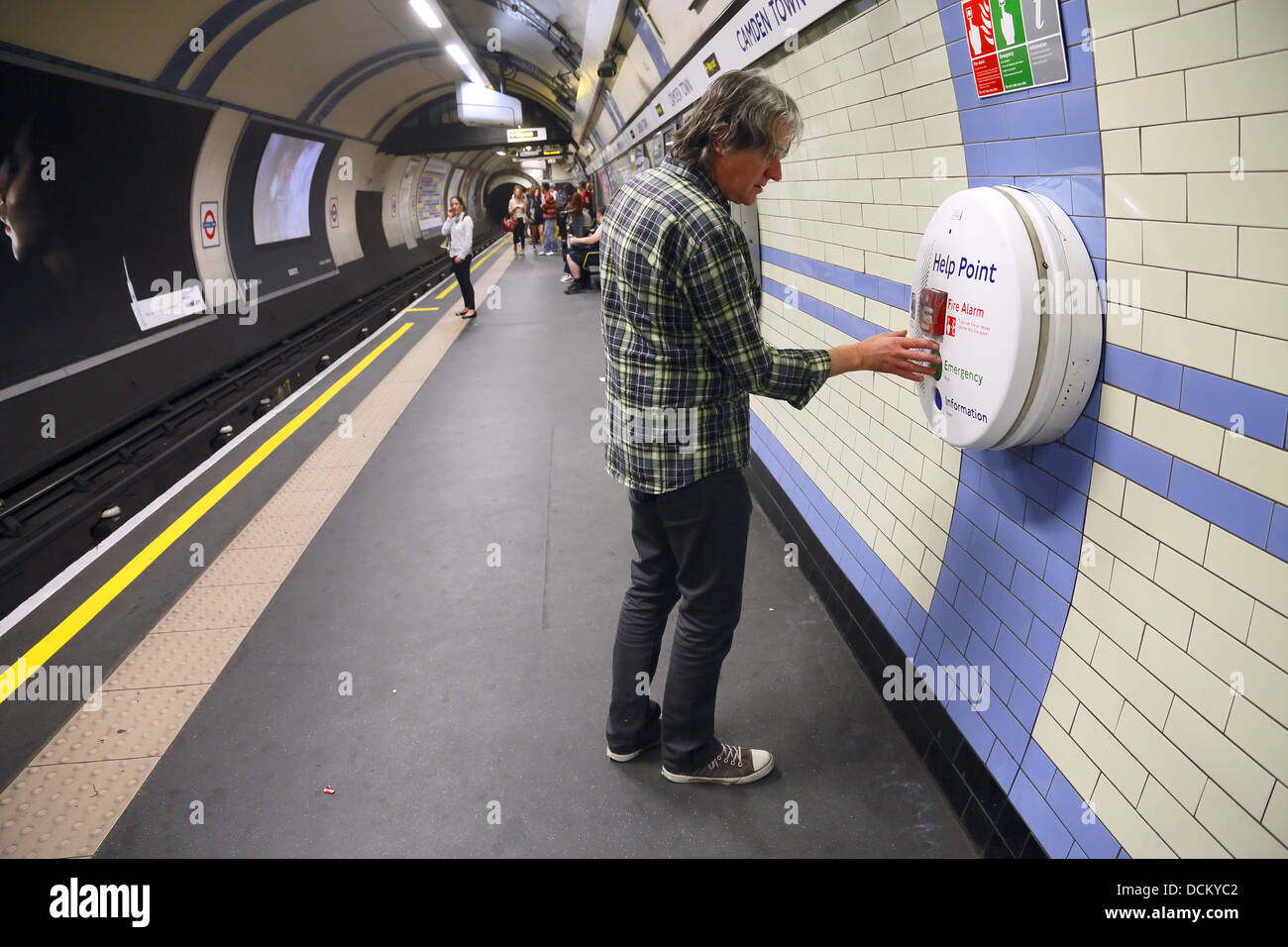 Passenger using a London underground help point Stock Photo - Alamy