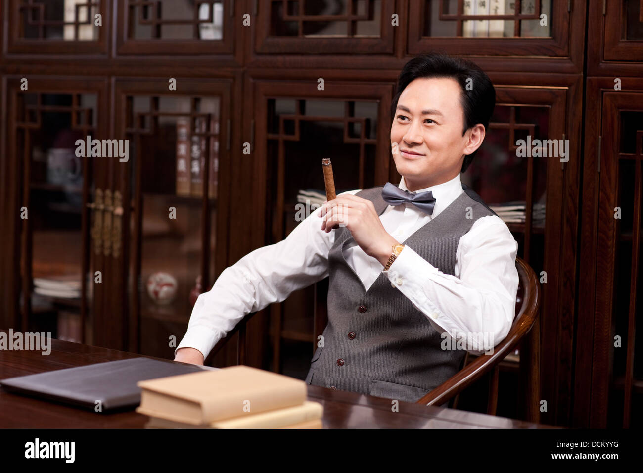 Successful businessman with cigar Stock Photo - Alamy