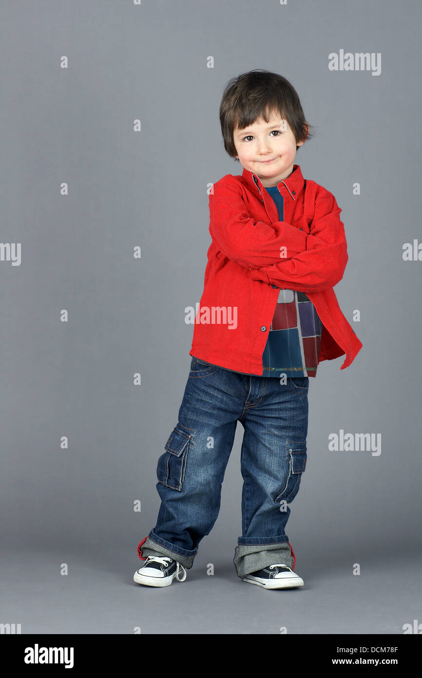 Cute little boy in red leaning Stock Photo - Alamy