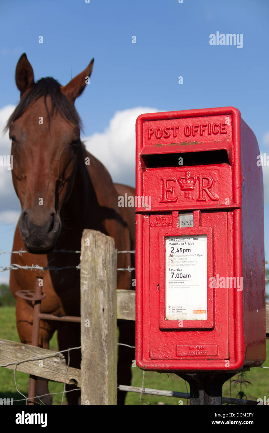 Village of Coddington, England. A red Post Office letter post box with ...