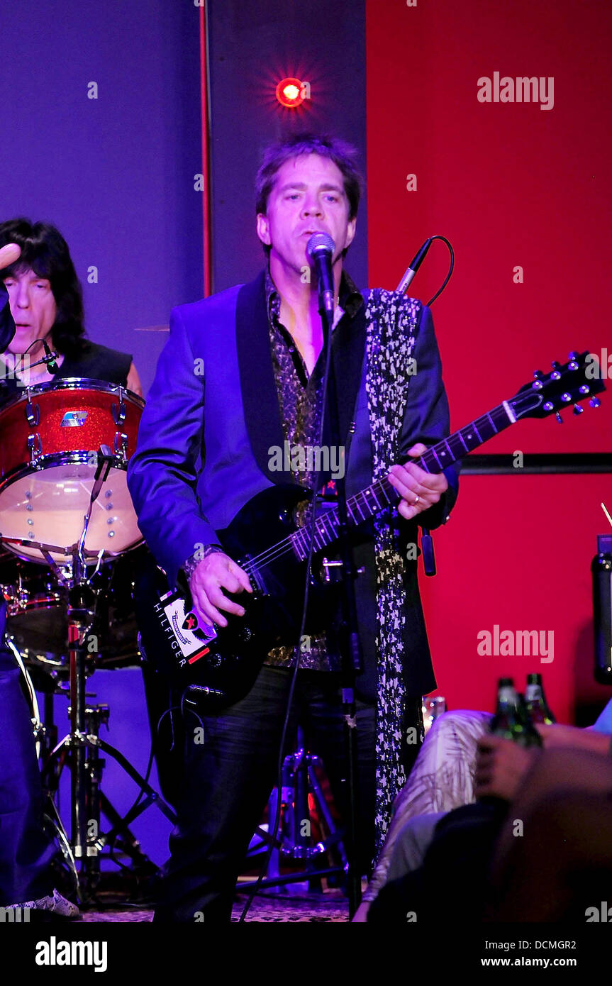 Andy Hilfiger performs after his introduction of a rock inspired ...