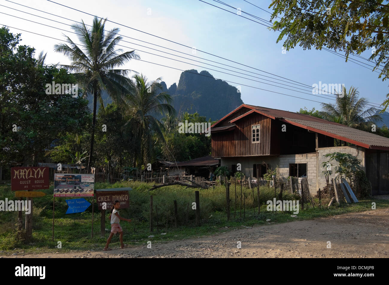 Horizontal view of traditional half built wooden home along a rough ...