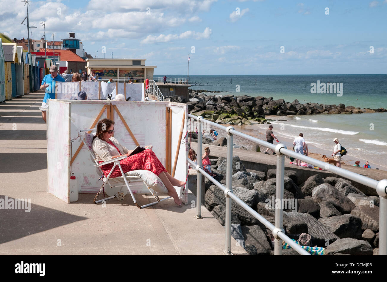 woman reading book on promenade, sheringham, norfolk, england Stock ...