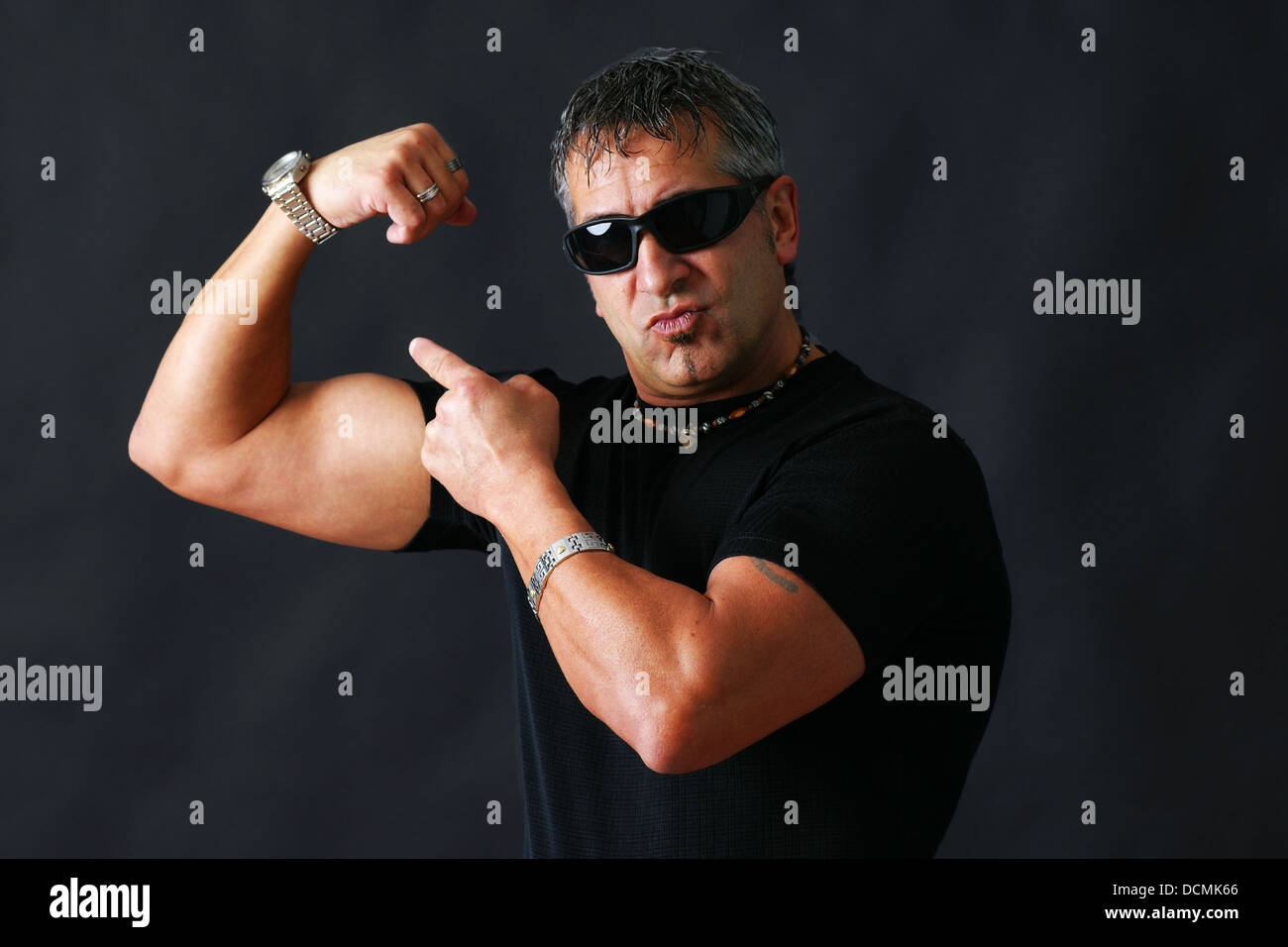Tough guy showing off Stock Photo - Alamy