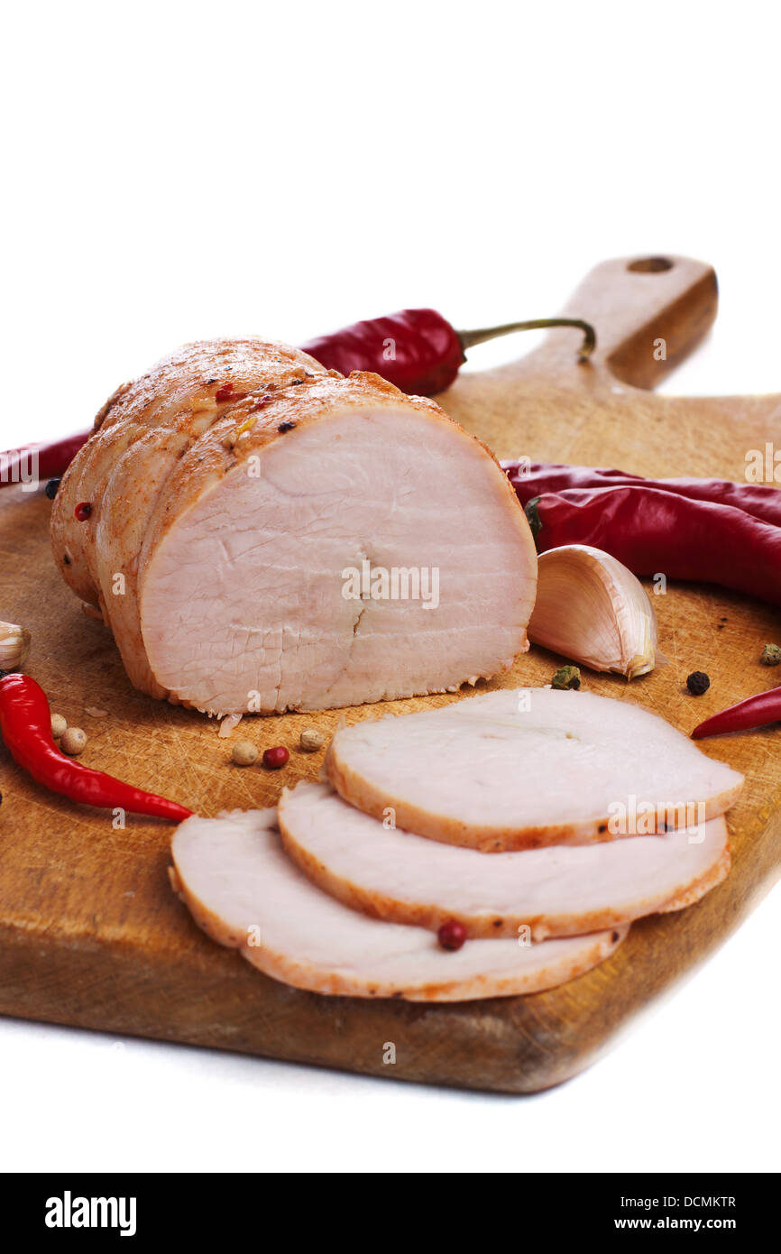 Homemade turkey ham with red chili peppers isolated Stock Photo - Alamy
