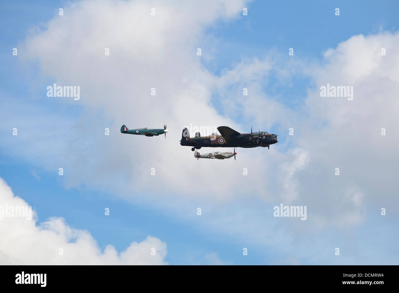 Horizontal view of a Lancaster bomber flanked by two spitfires flying ...