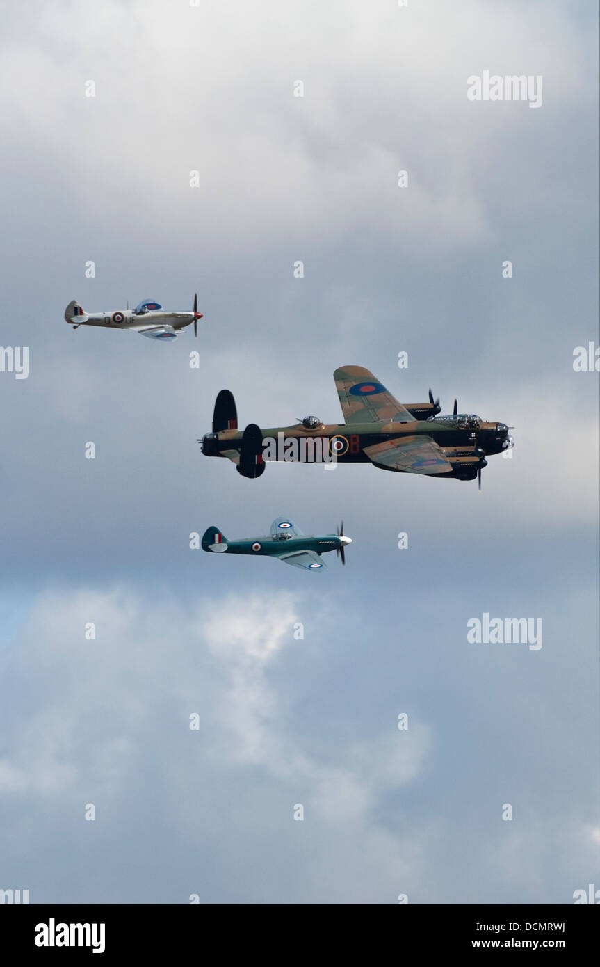 Vertical view of a Lancaster bomber flanked by two spitfires flying in ...