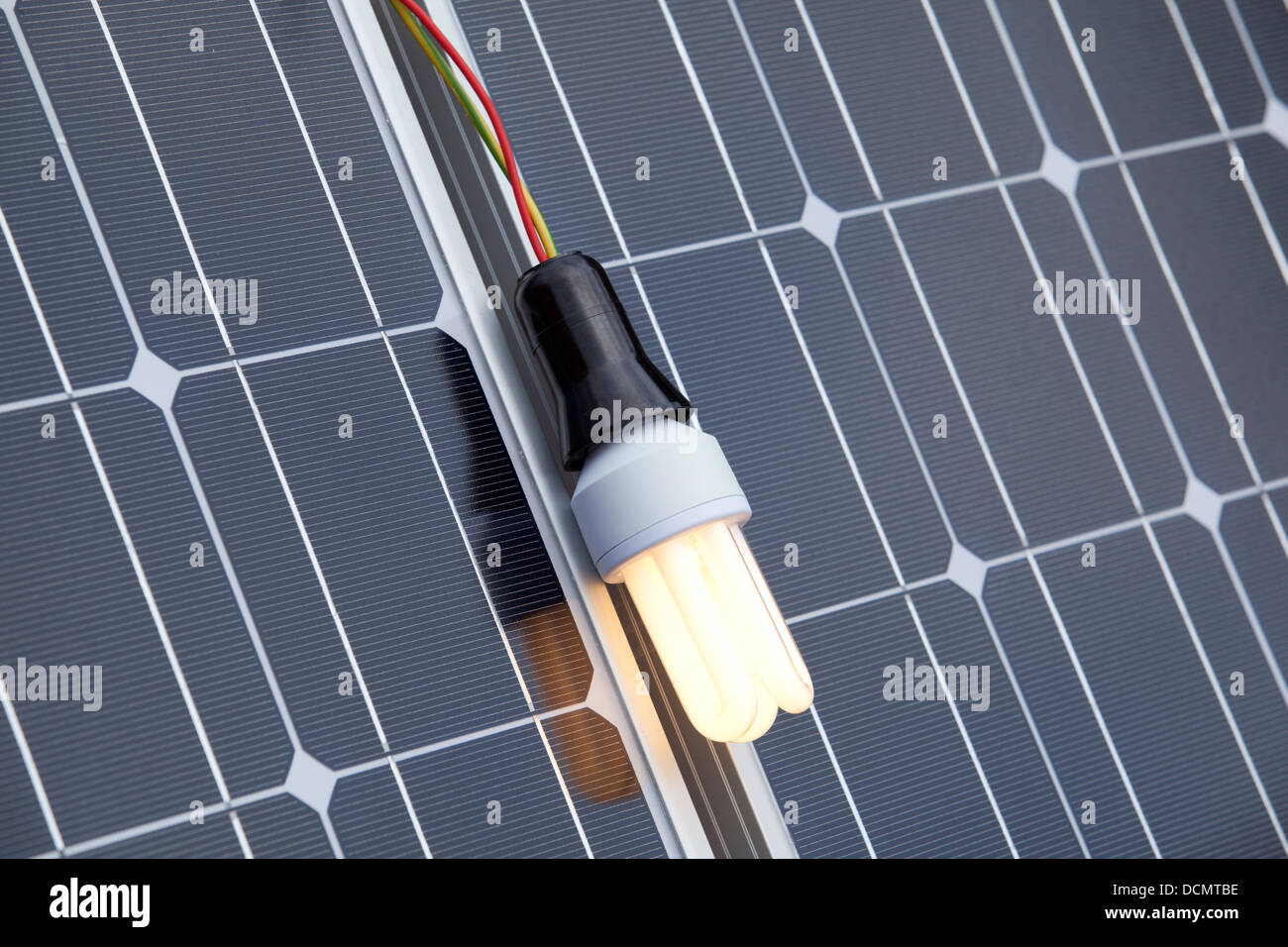 energy saving light bulb on the solar panel Stock Photo - Alamy