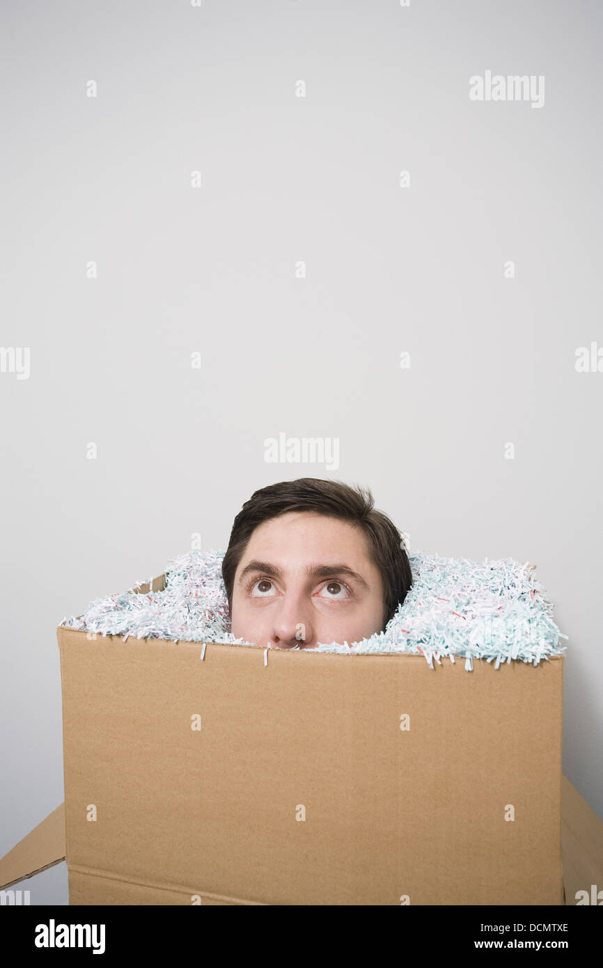 Office worker with head in a box Stock Photo - Alamy
