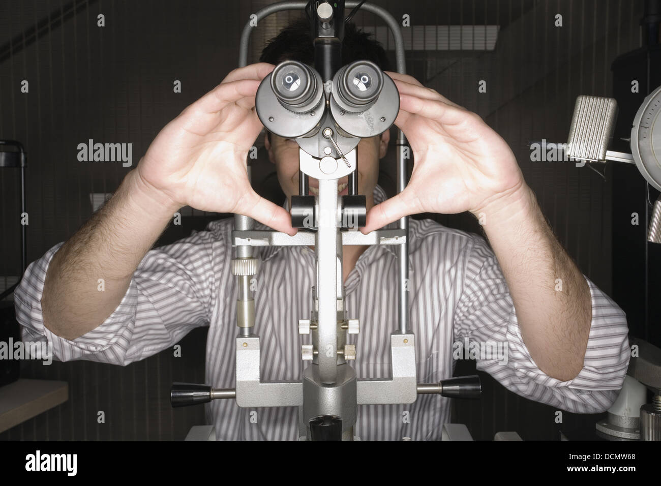 Patient at optometrist Stock Photo - Alamy
